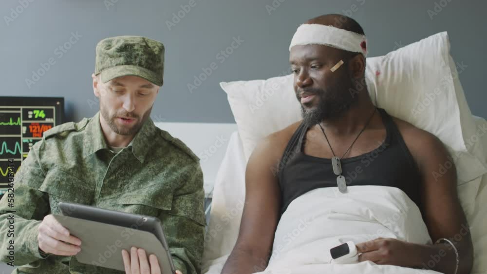 African American soldier with head injury and his Caucasian friend ...