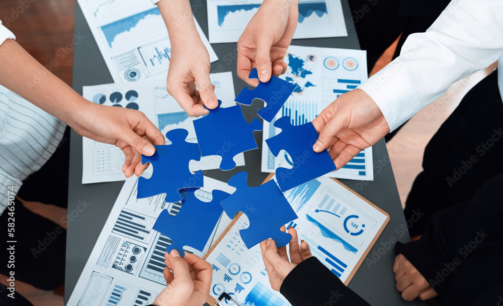 Closeup top view business team of office worker putting jigsaw puzzle ...