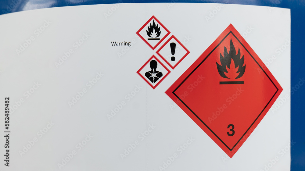 A 200 liter drum mounted with a chemical hazard warning label displays ...