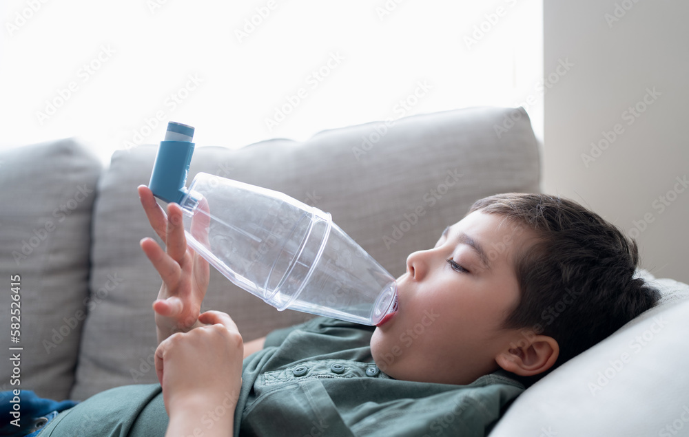 Sick child using asthma inhaler for allergies,Poor boy tired from chest ...