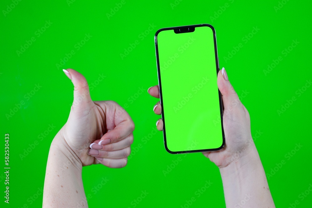 Show thumb up class IPhone 13 pro max with a vertical green screen with ...