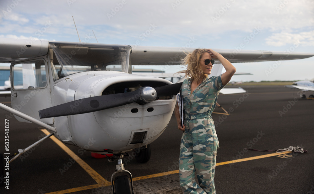 Woman in military uniform checks on a small aviation airplane. Flight ...