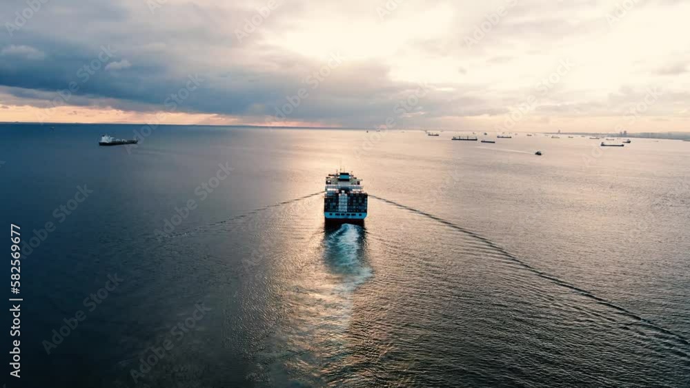 Aerial top view Container ship full load container on the green sea ...