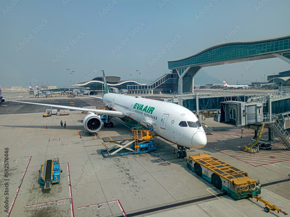 Hong Kong - March 1, 2023: Airplane at boarding gate jet bridge in Hong ... Hong Kong - March 1, 2023: Airplane at boarding gate jet bridge in Hong ...