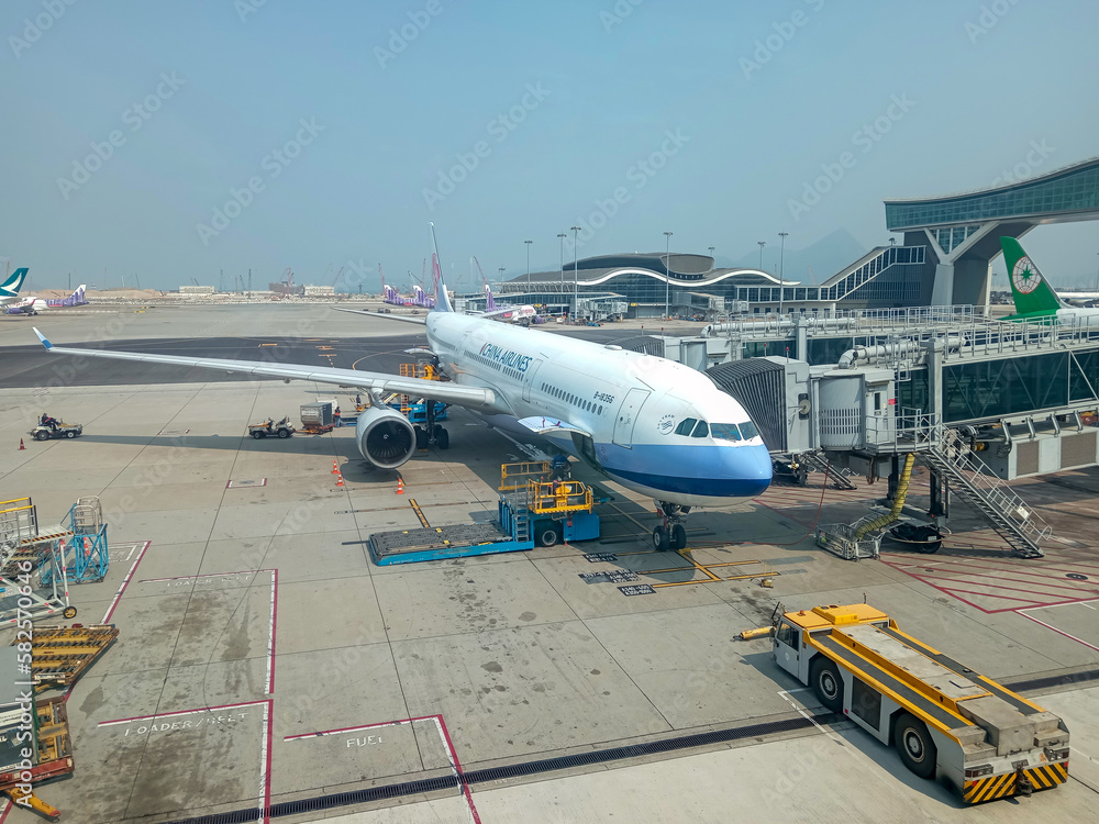 Hong Kong - March 1, 2023: Airplane at boarding gate jet bridge in Hong ... Hong Kong - March 1, 2023: Airplane at boarding gate jet bridge in Hong ...