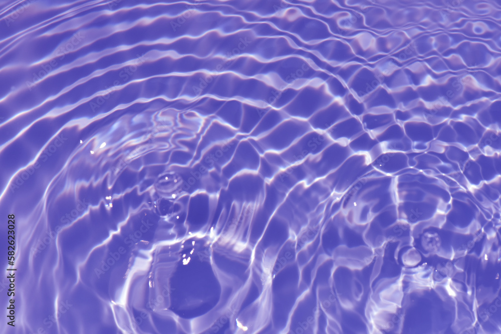 Defocus blurred transparent purple colored clear calm water surface ...