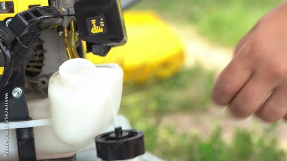 Refueling off petrol lawn grass weed trimmer with internal combustion ...