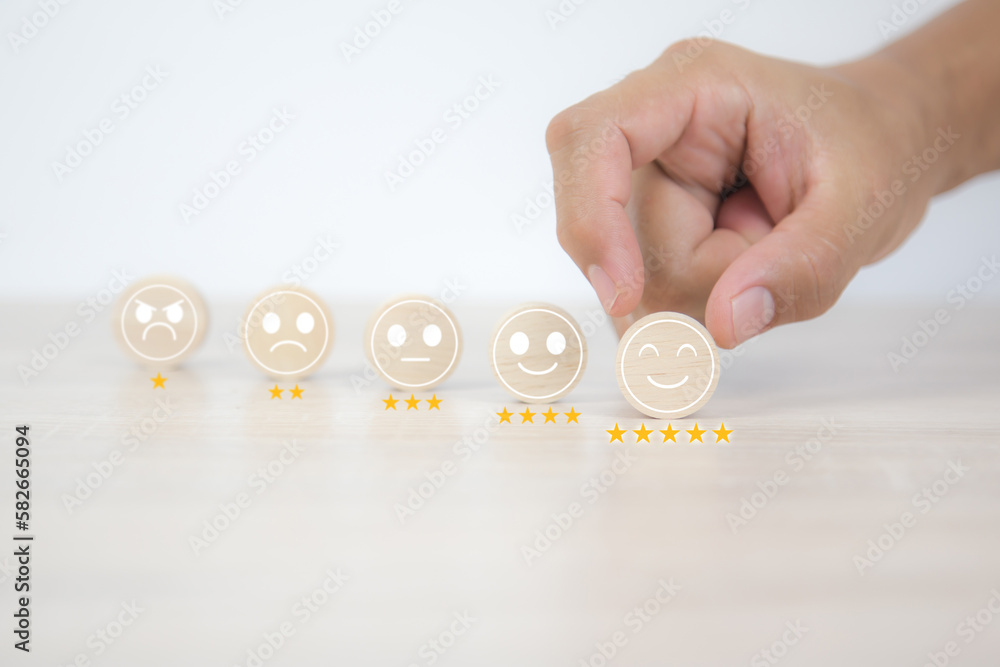 Smiley face on wooden toy for customer services rating feedback ...