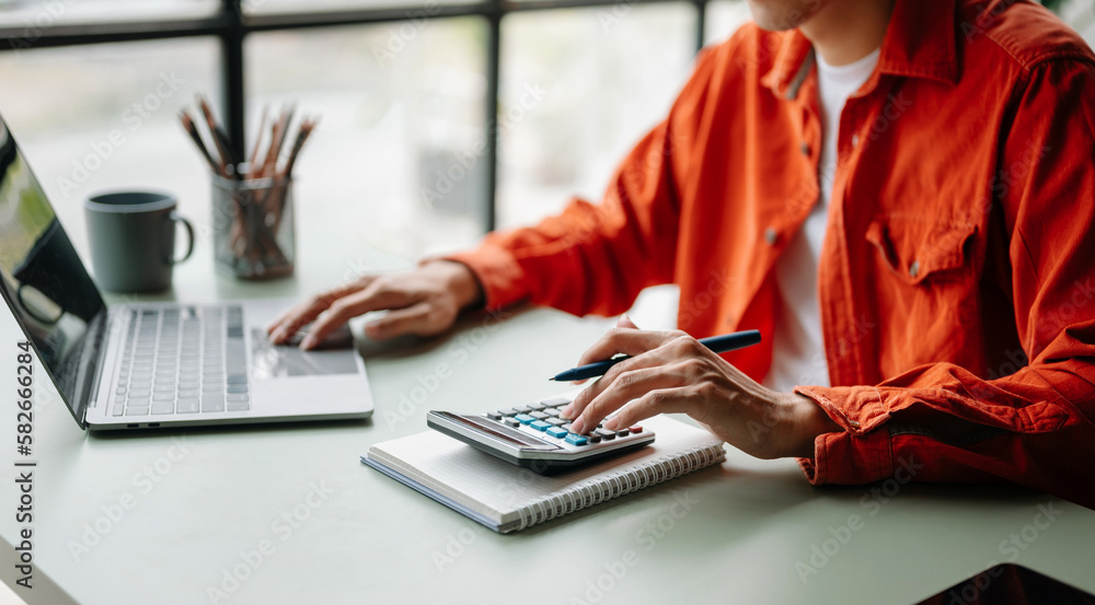 Women counting coins on calculator taking from the piggy bank. hand ...