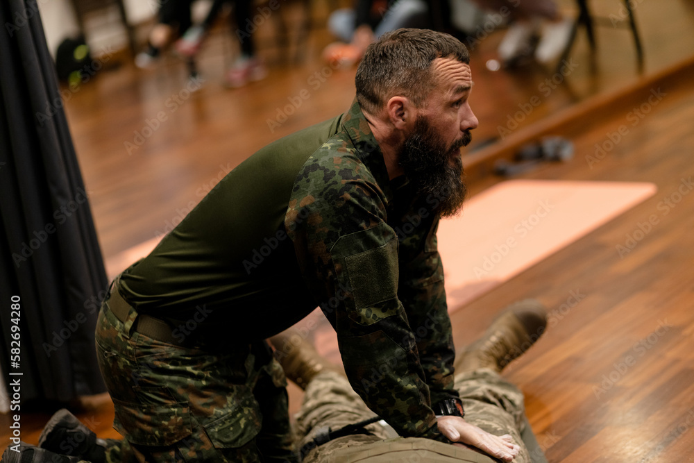 A 40-year-old bearded military medic demonstrates how he applies hand ...