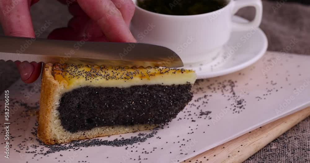 cut Delicious poppy seed cake with a thin sponge cake and lots of poppy ...