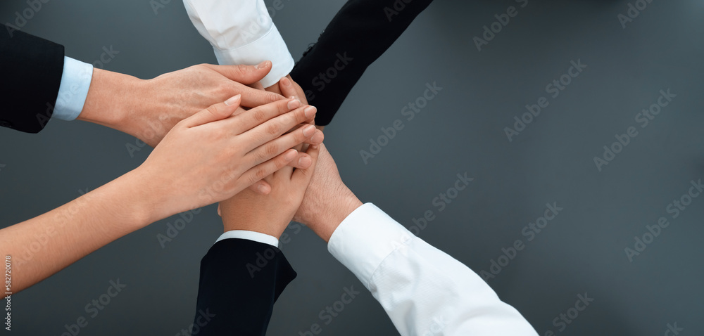 Top view partial hands wearing formal suit joining stack and form ...