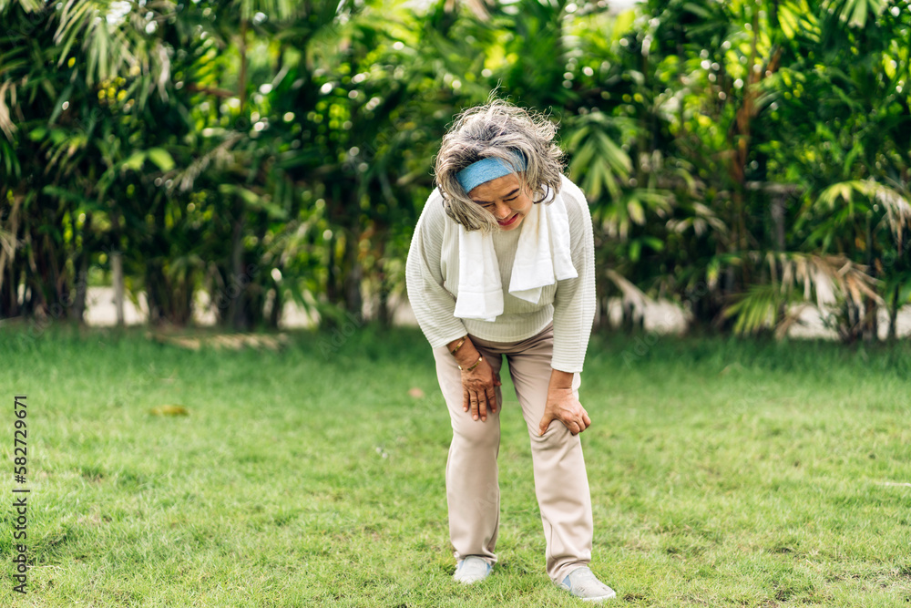 Sick unhappy senior adult elderly asian woman touching her muscle ...