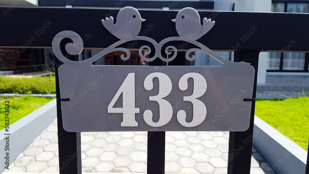 Number on gray plastic plate installed on the black metal gate Stock ...