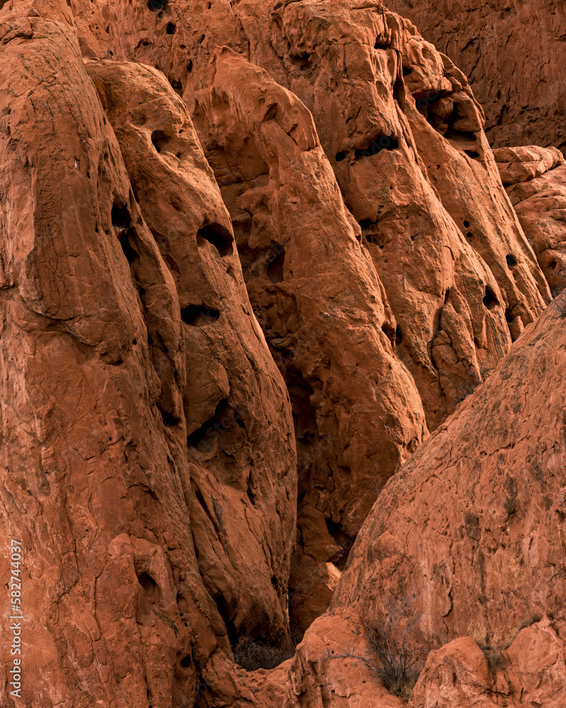 Red sandstone rock features, showing interesting texture, pits and pock ...