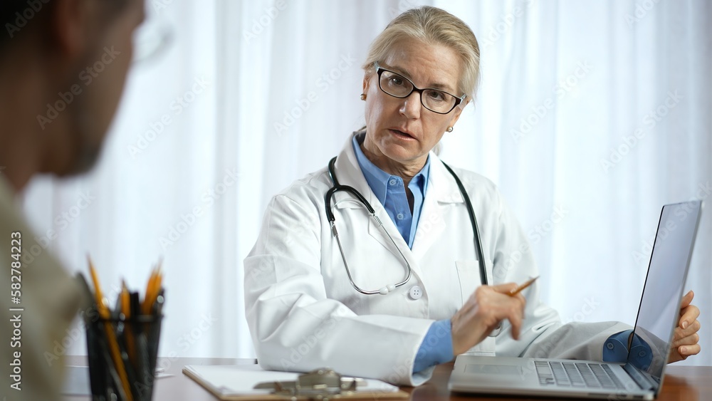 Woman doctor discuss healthcare issues and fill out paperwork with ...