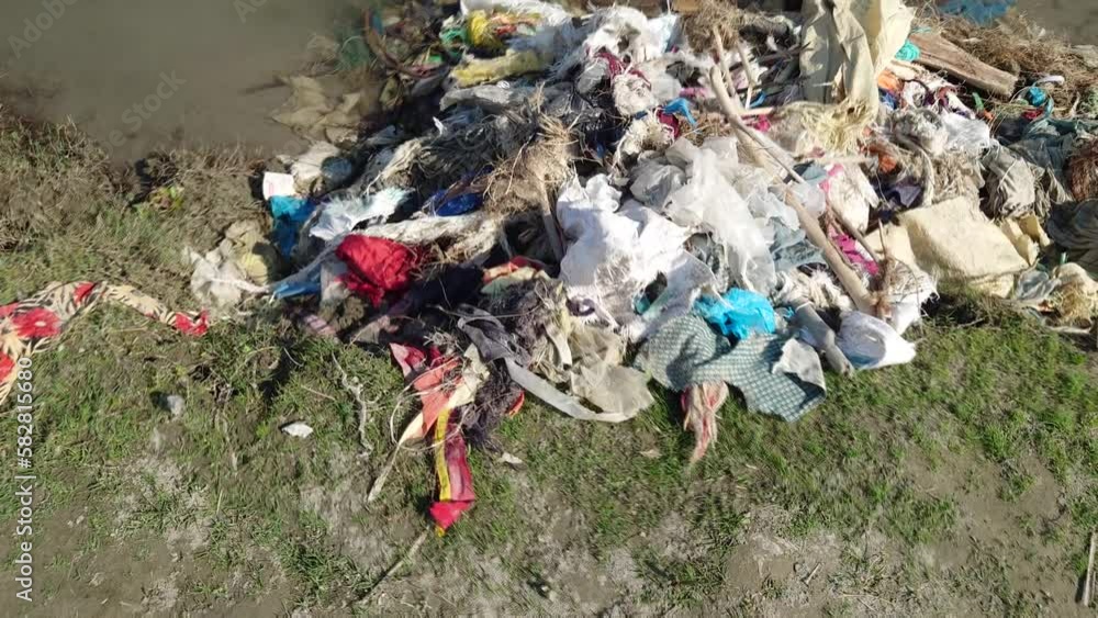 Plastic pollution trash beside river bank with different kinds of ...