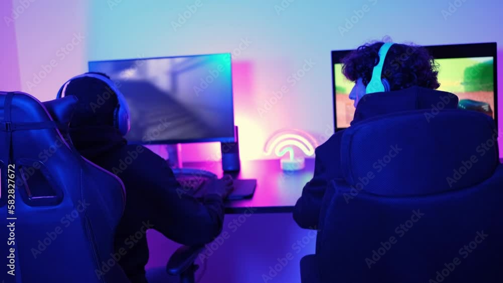 Two gamers from different backgrounds playing video games together and ...