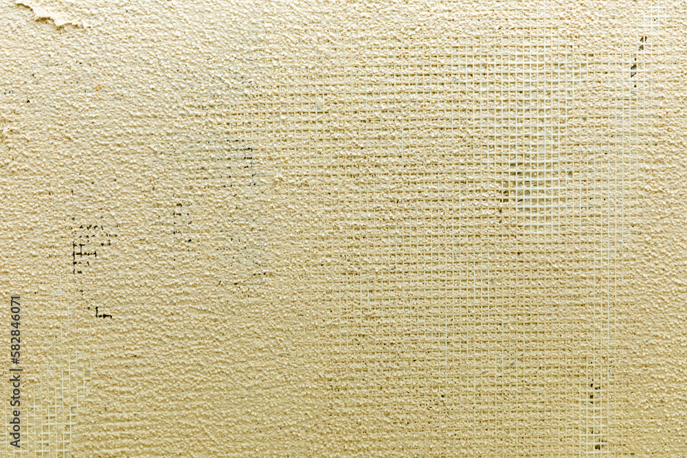 plastering a new modern house wall with plastic grid on a PVC ...