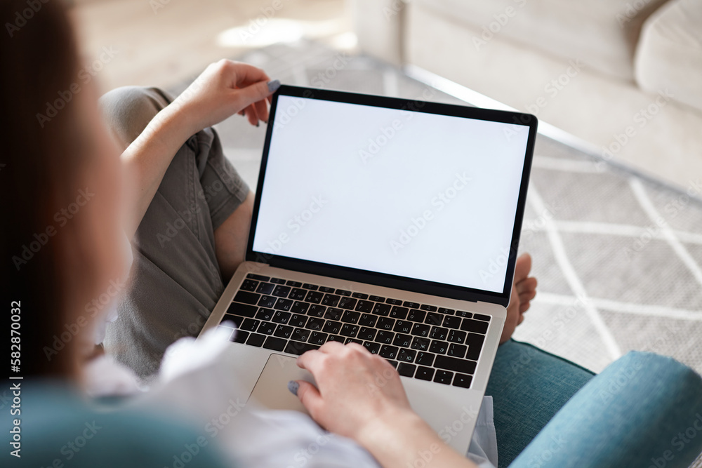 Mockup white screen laptop woman using computer sitting on armchair at ...