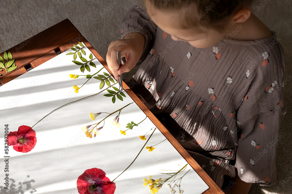 Child making herbarium in home. Children's creativity. preparations for ...