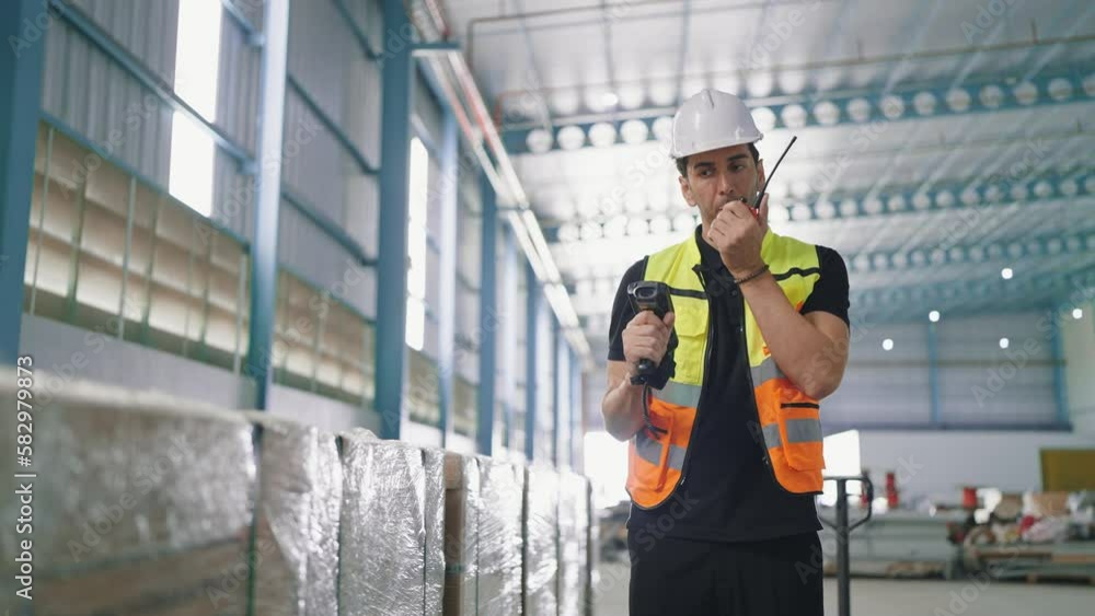 Professional young engineer man holding barcode scanner and radio ...