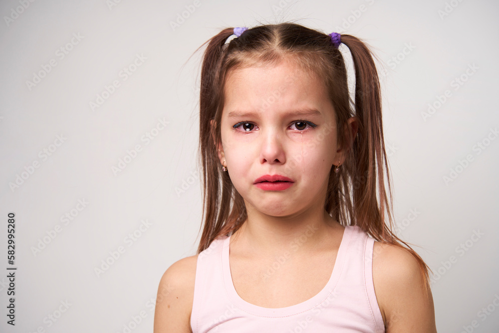 Crying child girl against white background Stock Photo | Adobe Stock