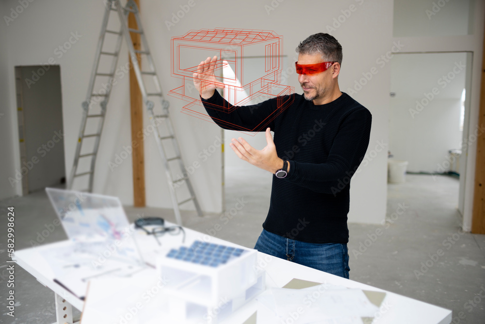 Architect wearing virtual reality simulator examining house model and ...