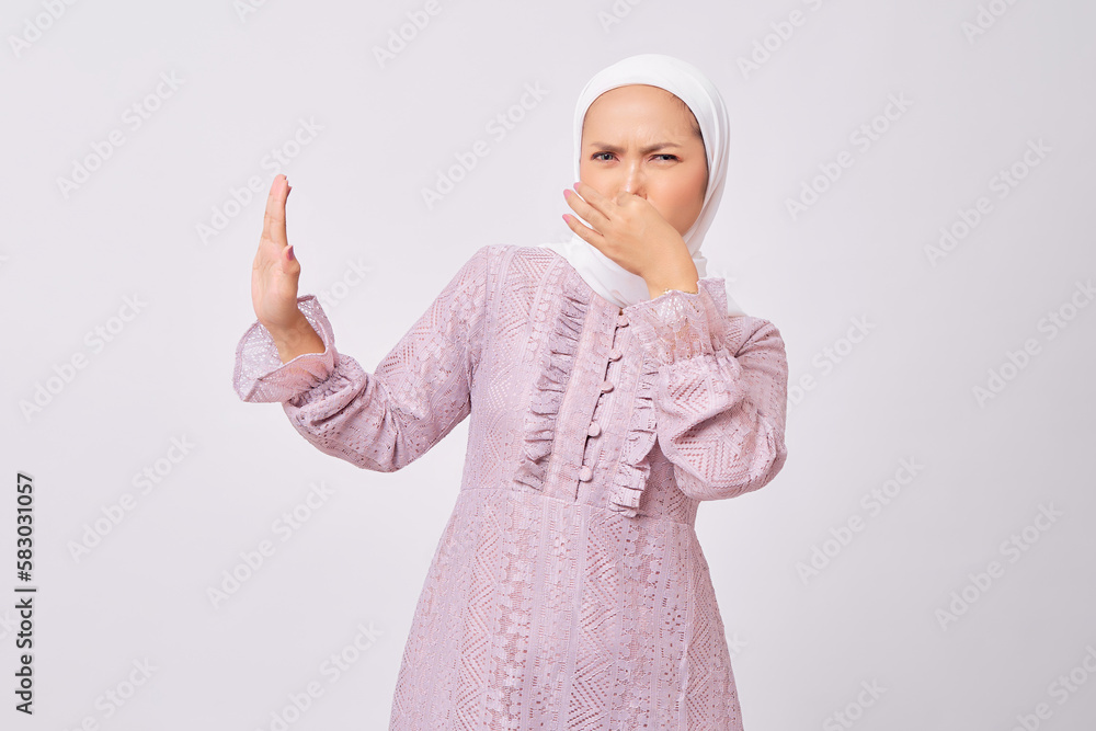 Portrait of serious beautiful young Asian Muslim woman wearing hijab ...