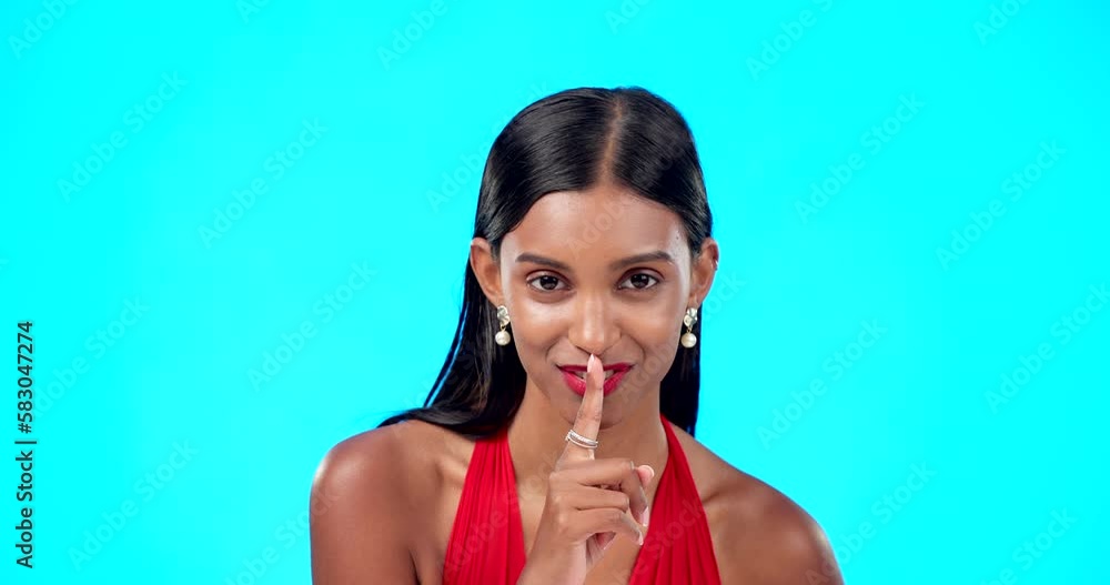 Video Stock Secret, face and woman with finger on lips in studio, blue ...
