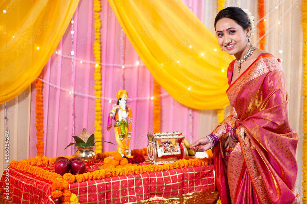 Beautiful Indian woman worshiping god - Smiles looking towards the ...