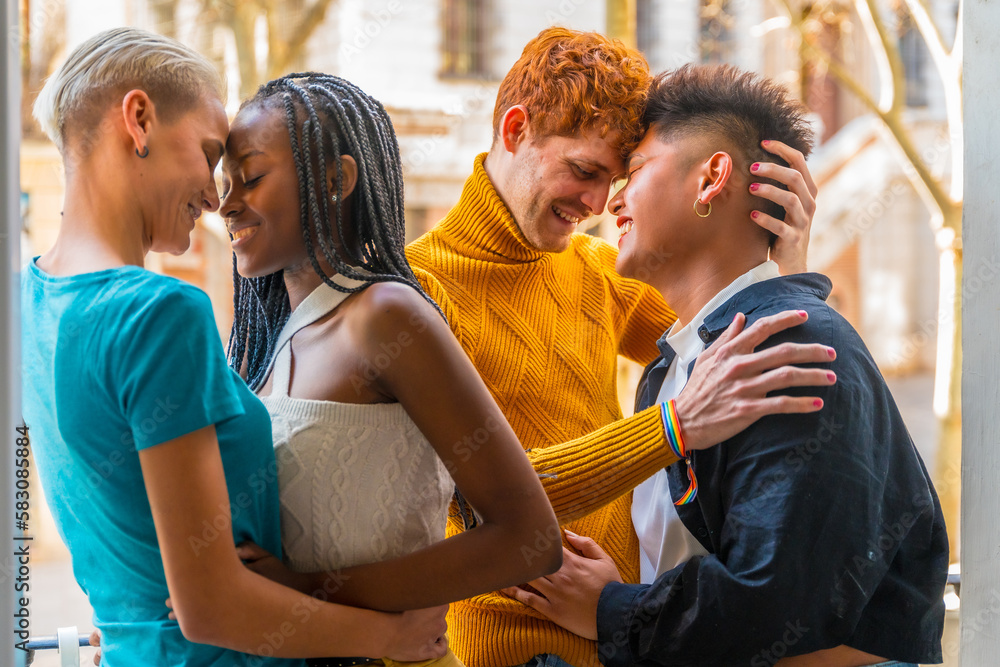Portrait of couples of gay boys and lesbian girls embraced giving each ...