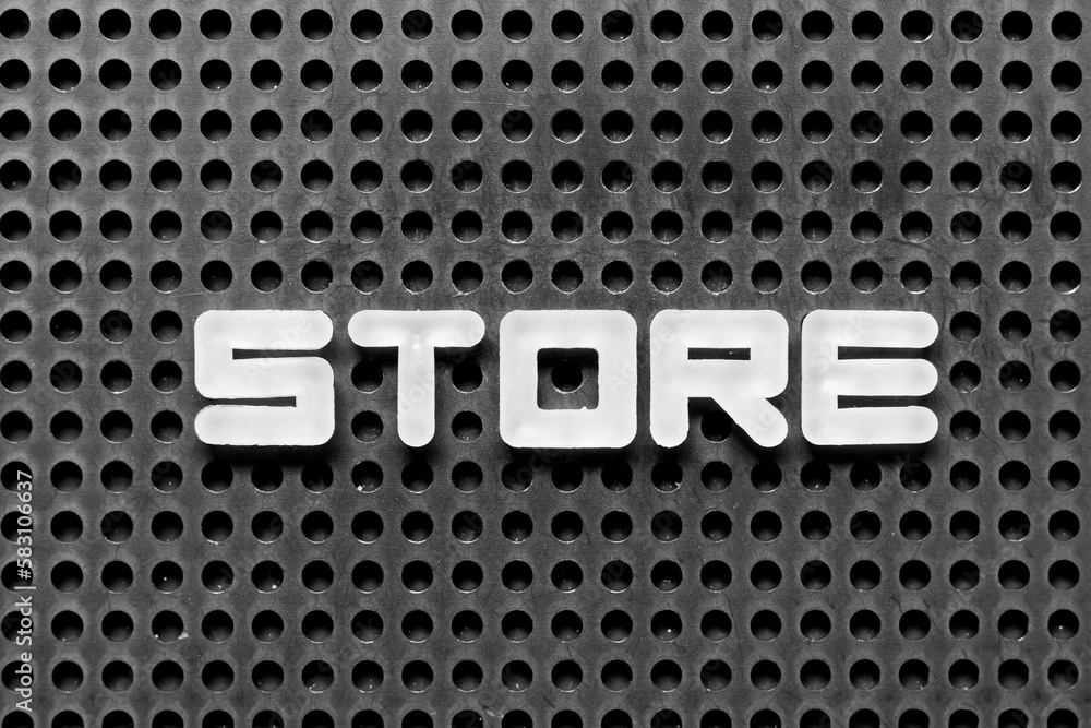 White alphabet letter in word store on black pegboard background Stock ...