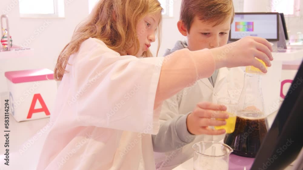 School kids in the modern educational laboratory using test tubes and ...