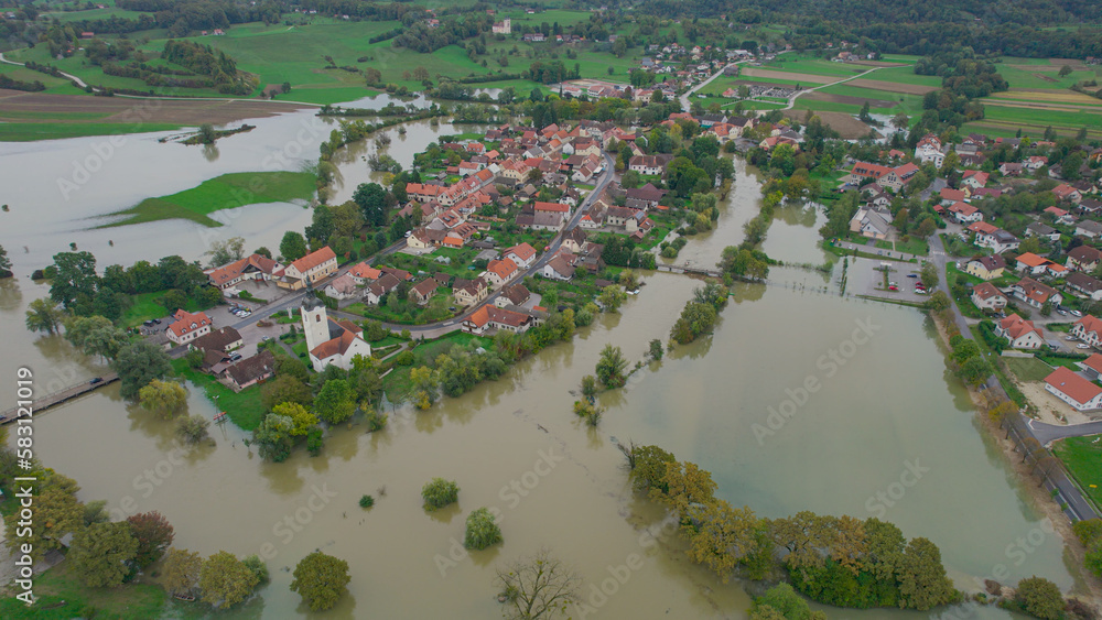AERIAL Autumn flooding around rural village with large areas of muddy ...