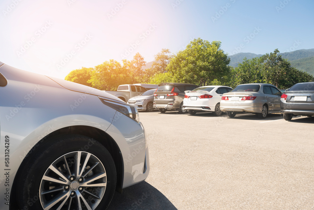 Cars parking in asphalt parking lot in a row with blue sky background ...