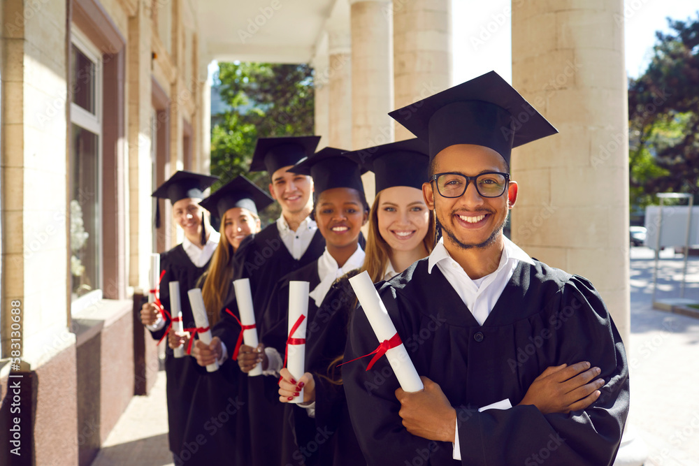 Groups of happy and joyful graduates in academic gowns and academic ...