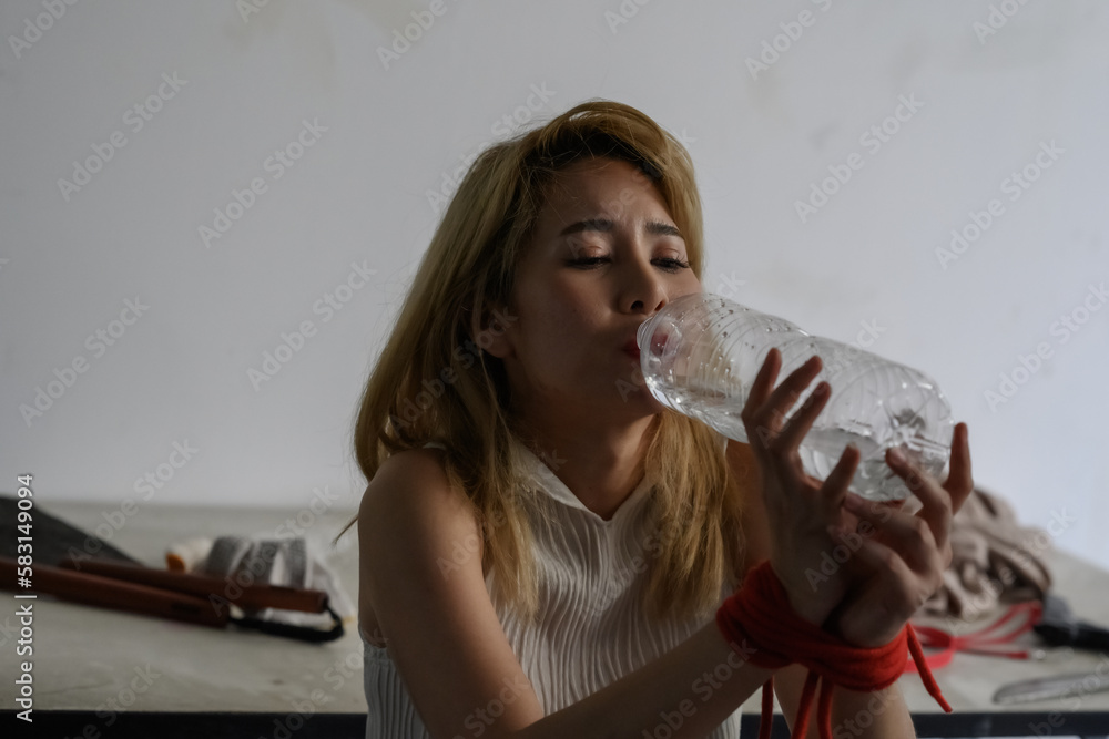 poor woman kidnapped or held hostage by being bound with a red rope was ...