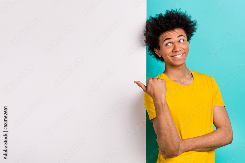 Portrait of good mood nice guy wear yellow t-shirt look directing empty ...