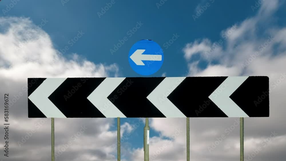 Zoom to a sharp change of direction road sign. A sharp turn to the left ...