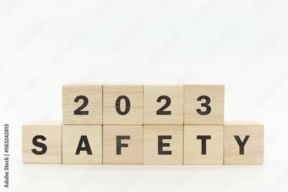 Wooden cubes 2023 and safety text on white background. Work safety in ...