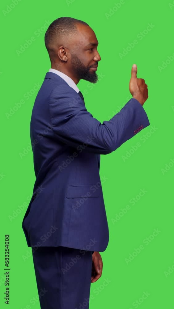 Vertical video: Profile of male employee showing thumbs up sign on ...