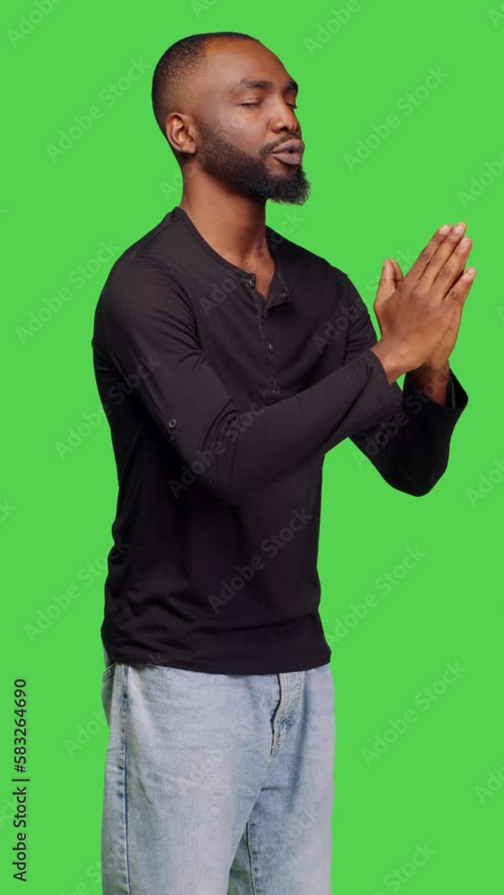 Vertical video: Side view of spiritual person praying to god in studio ...