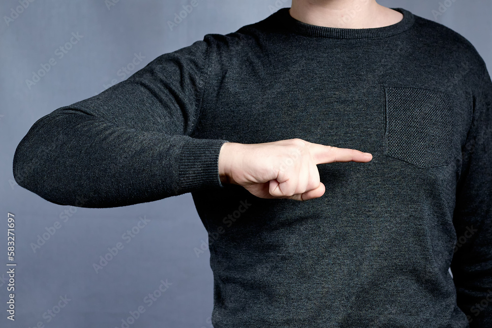 Hand with index finger showing direction to left. Directional or ...