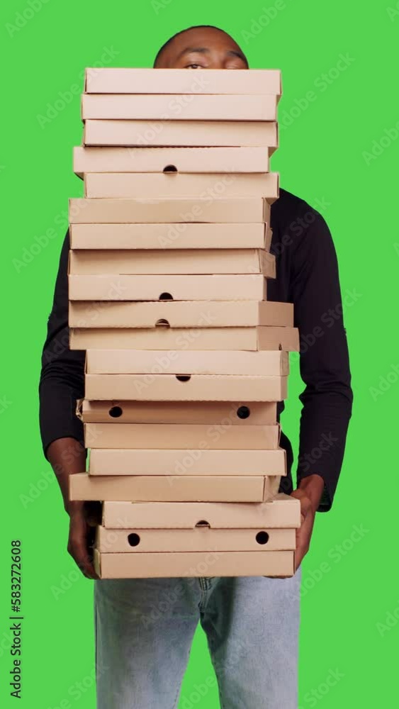 Video „Vertical video: Front view of african american man holding pile ...