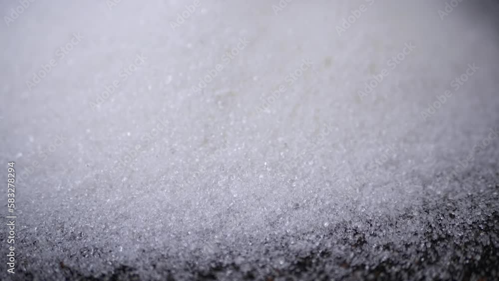 Stockvideon White Crystals of Granulated Sugar Fall on a Black ...