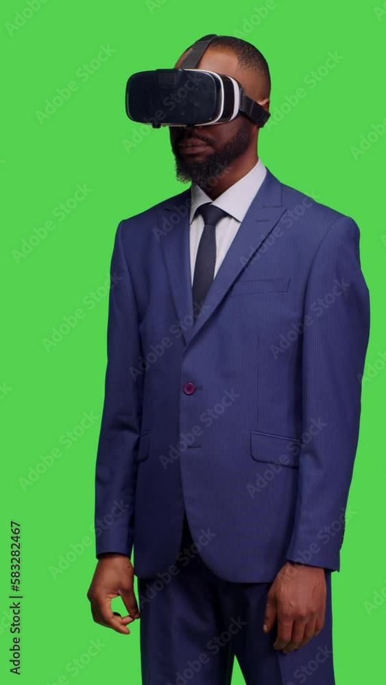 Vertical video: Side view of modern young businessman using virtual ...