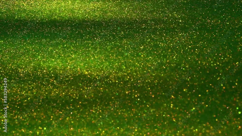Gold Particle Dust Dissolves in Green Liquid. Abstract scattering of ...