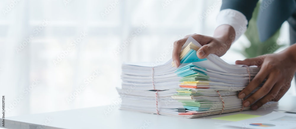 Paper stack, unfinished document, Close up hands of asian bookkeeper ...
