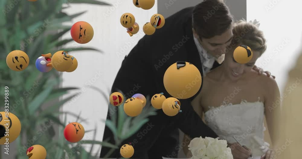 Animation of emoji icons over happy caucasian married couple signing ...